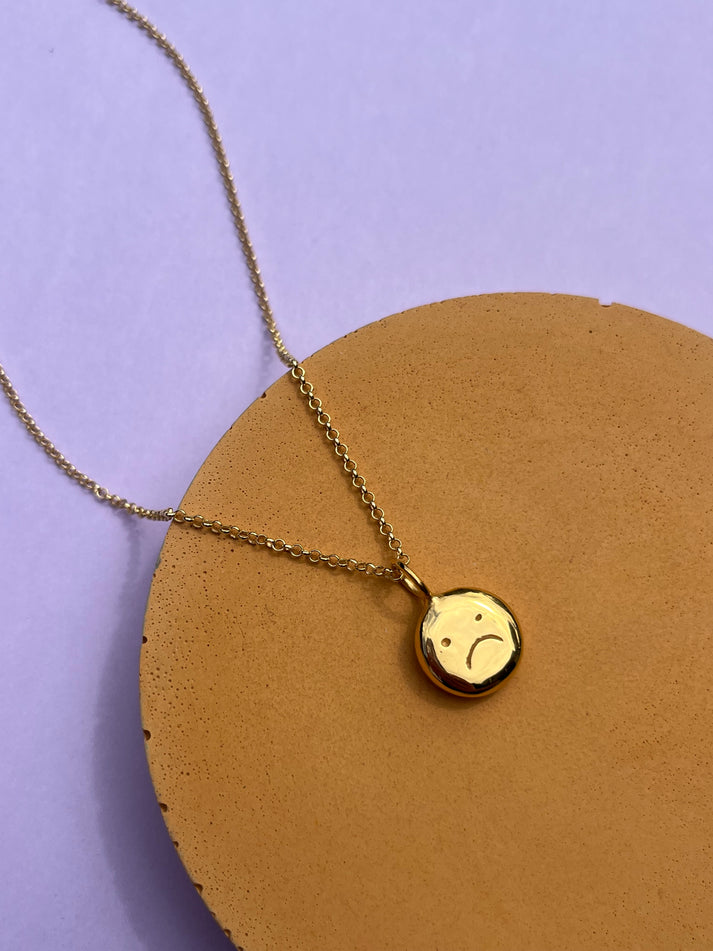 Gold plated sad face smiley pendant – Catherine Cox Studio